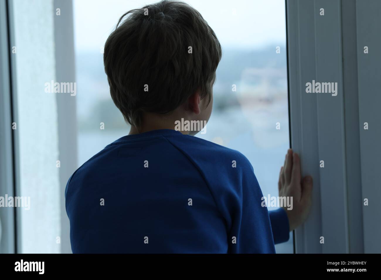Autism concept. Lonely little boy near window at home, back view Stock ...
