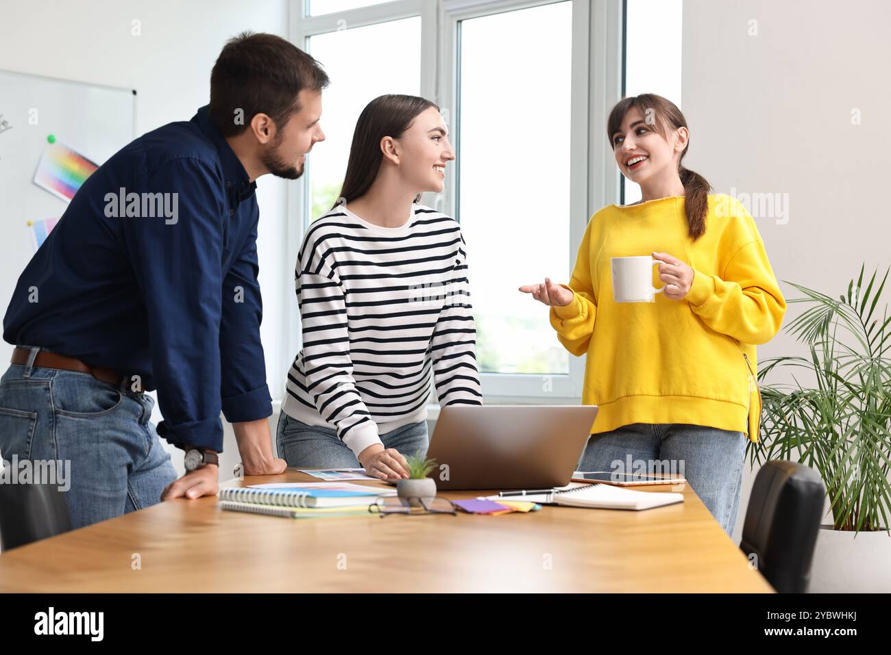 Group of designers working together in office Stock Photo - Alamy