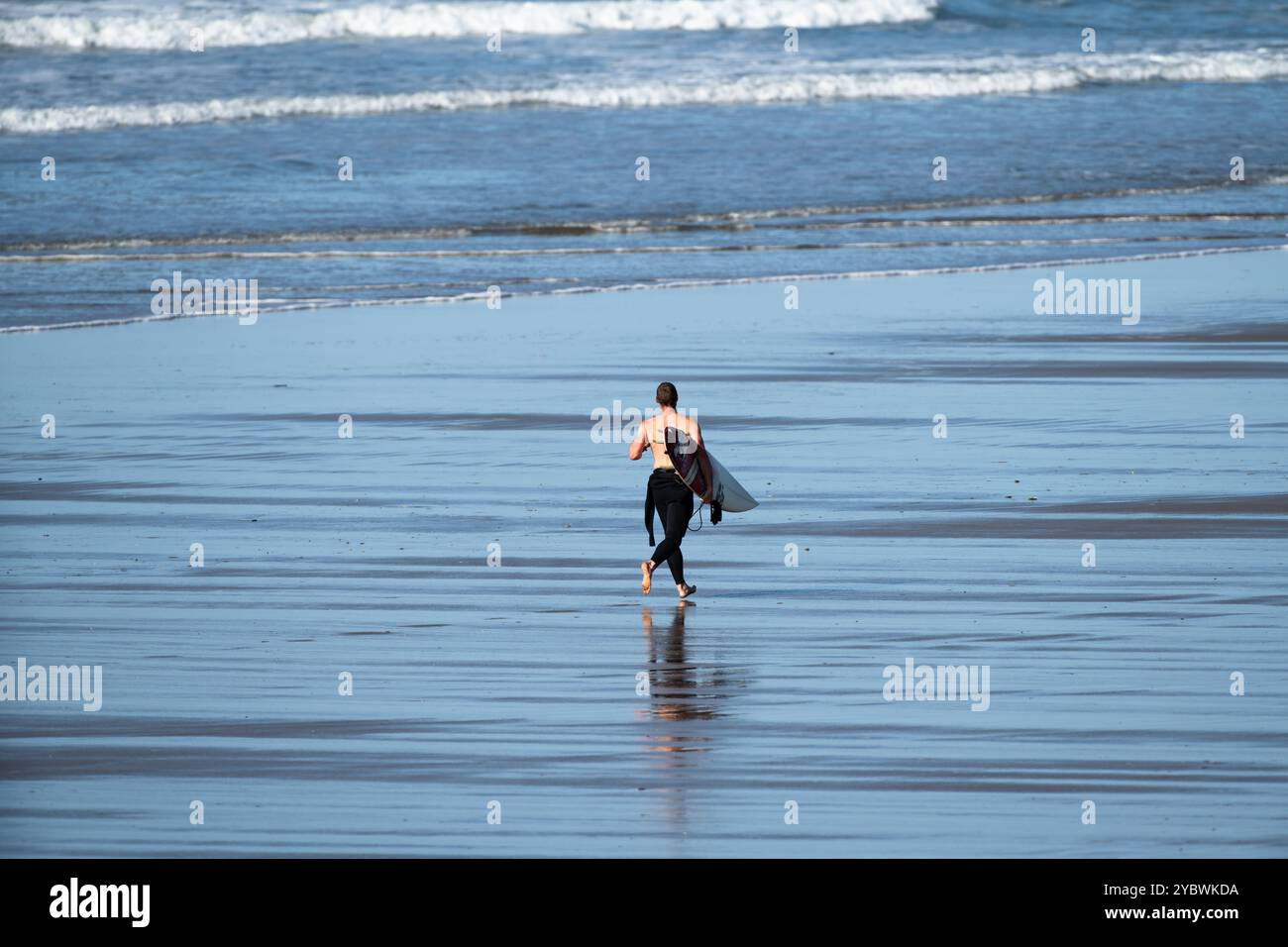 Surfer surfboard running on beach hi-res stock photography and images ...