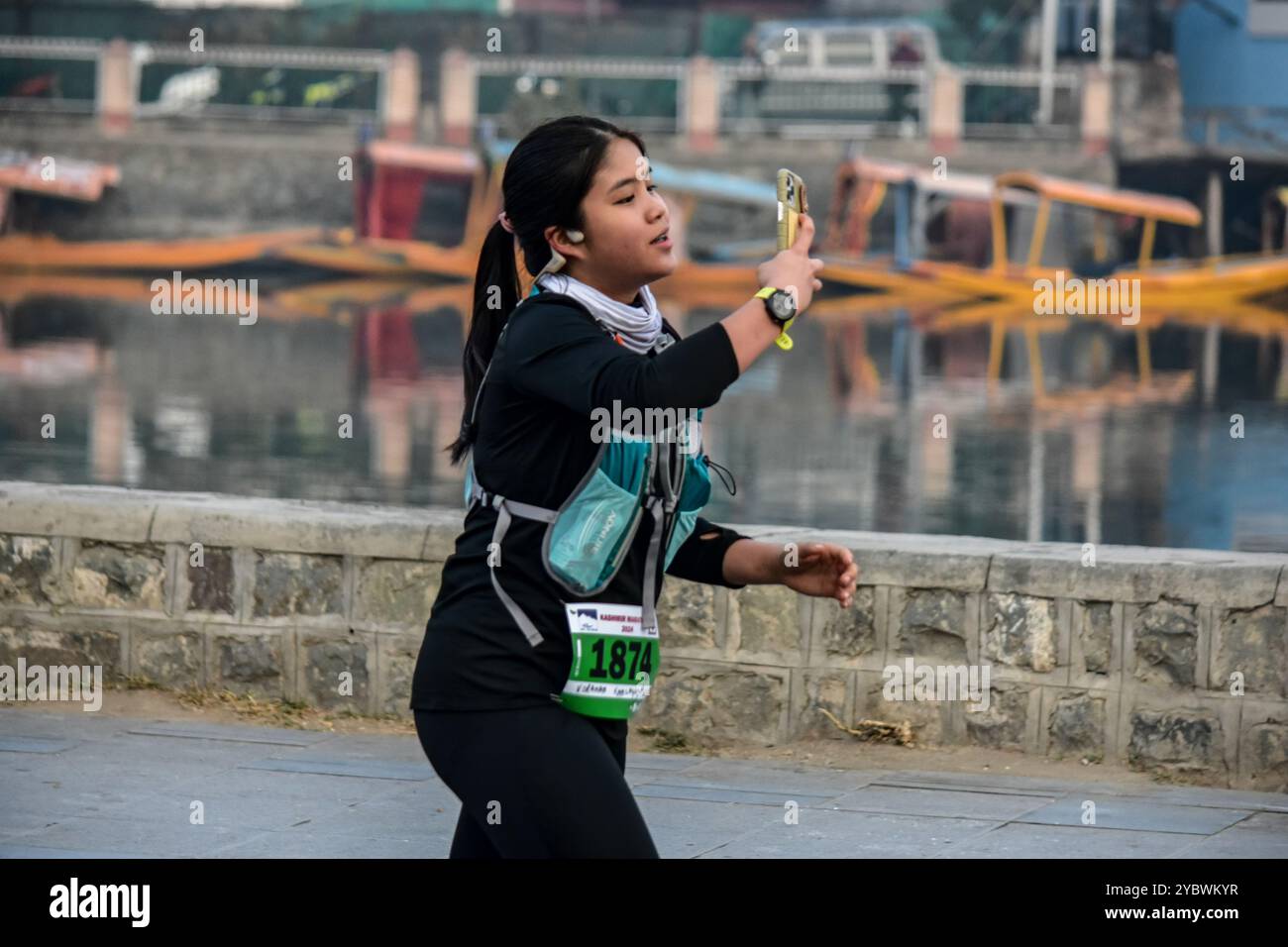 Srinagar, India. 20th Oct, 2024. An athlete takes photos as she ...