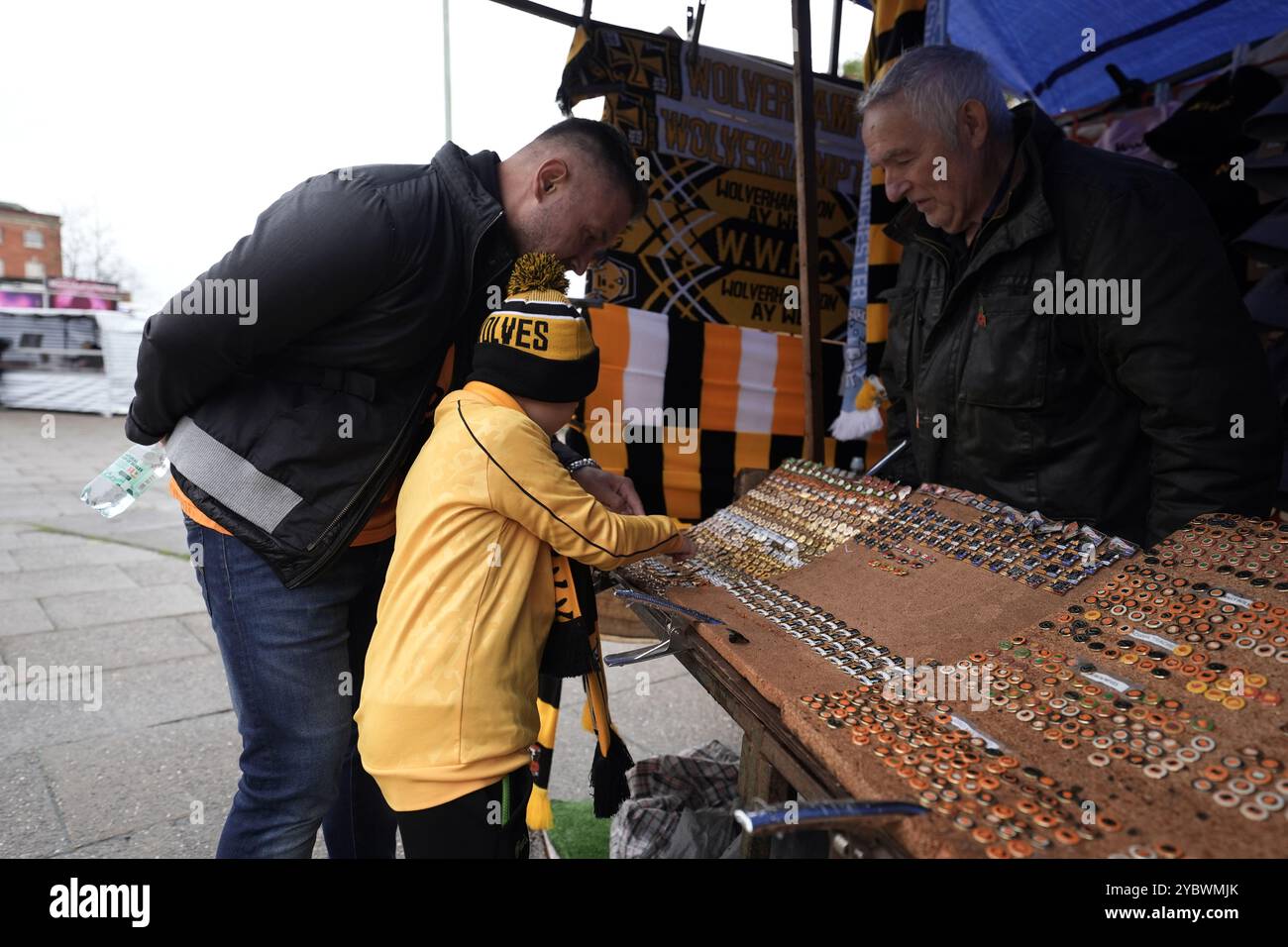 A young wolves fan buys a badge before the Premier League match at ...