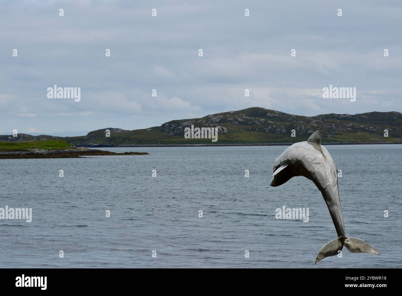 Metallic sculpture of a dolphin jumping in the sea by Lochmaddy Harbour ...