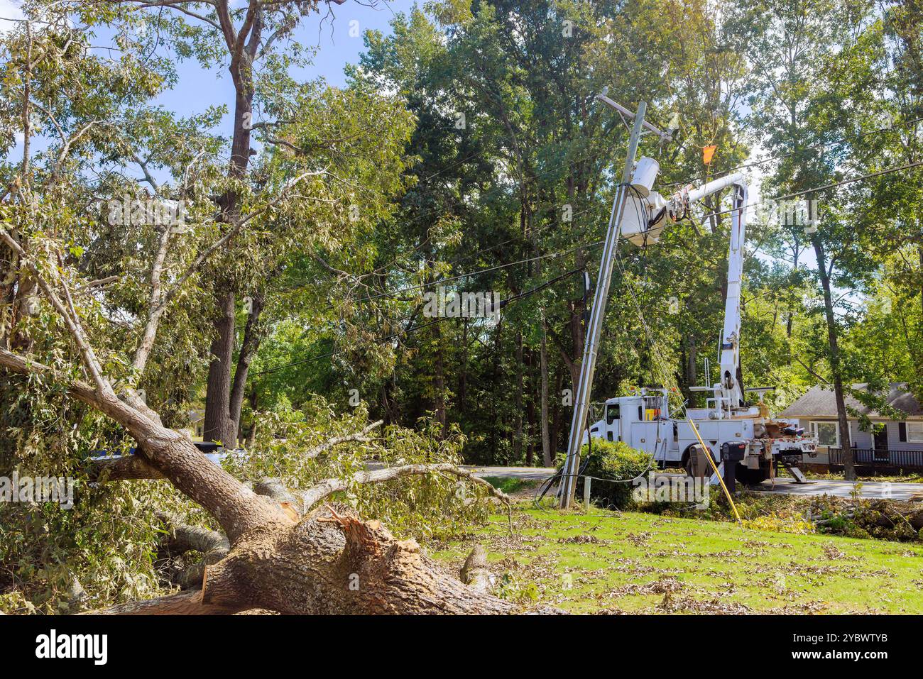 Using utility tower truck, emergency service linemen are diligently ...