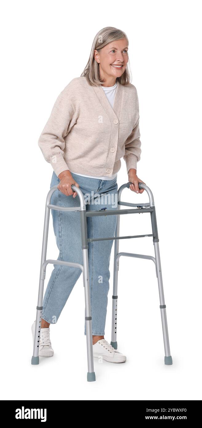 Senior woman using walking frame on white background Stock Photo - Alamy