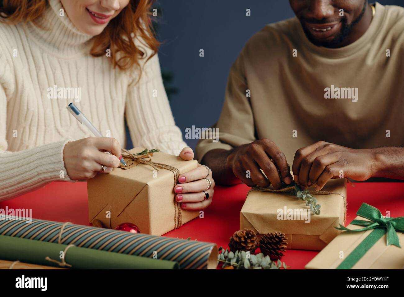 Family wrapping gifts together table hi-res stock photography and ...
