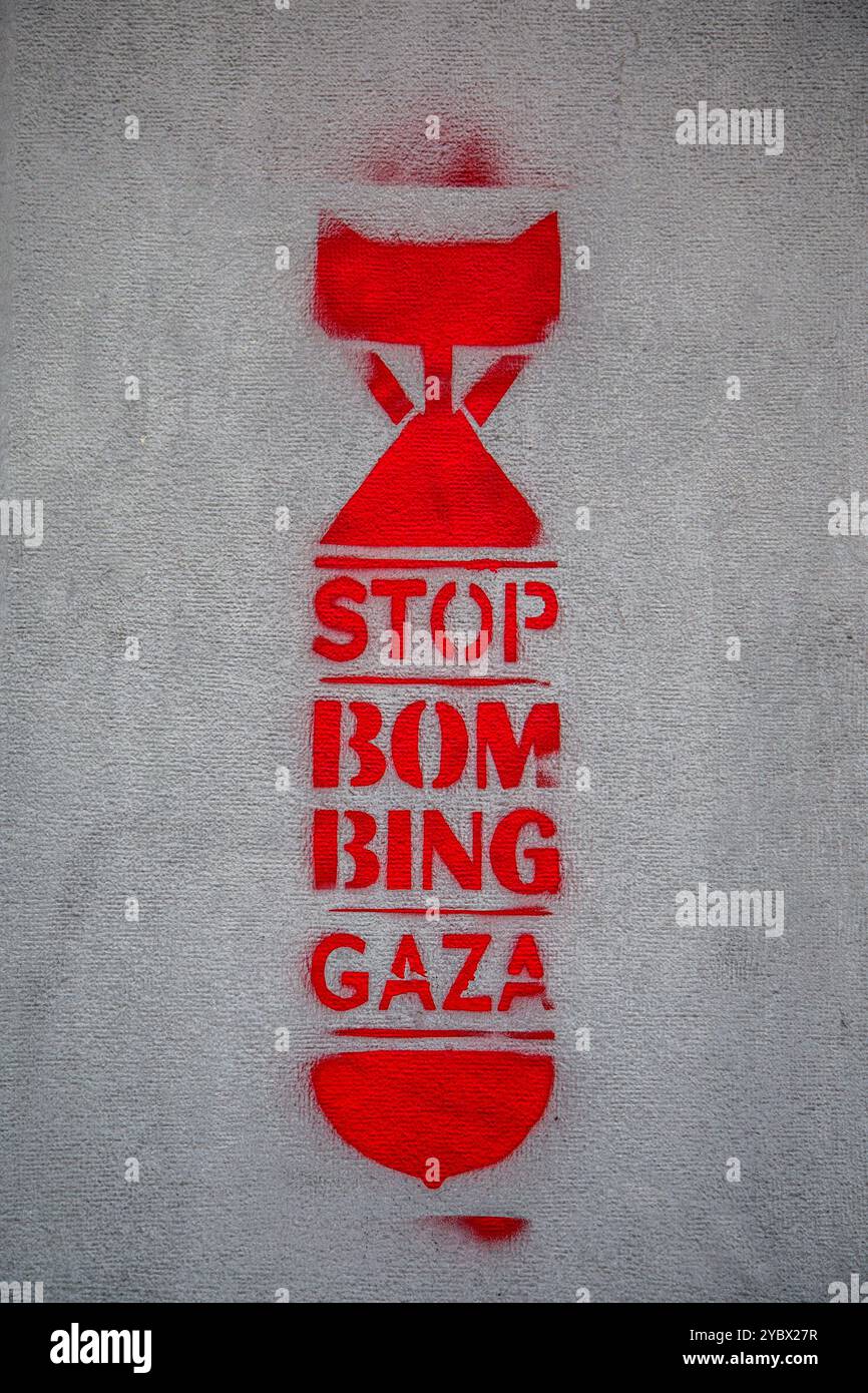Milan, Italy - March 9, 2014: Graffiti Stop bombing Gaza on the wall in ...