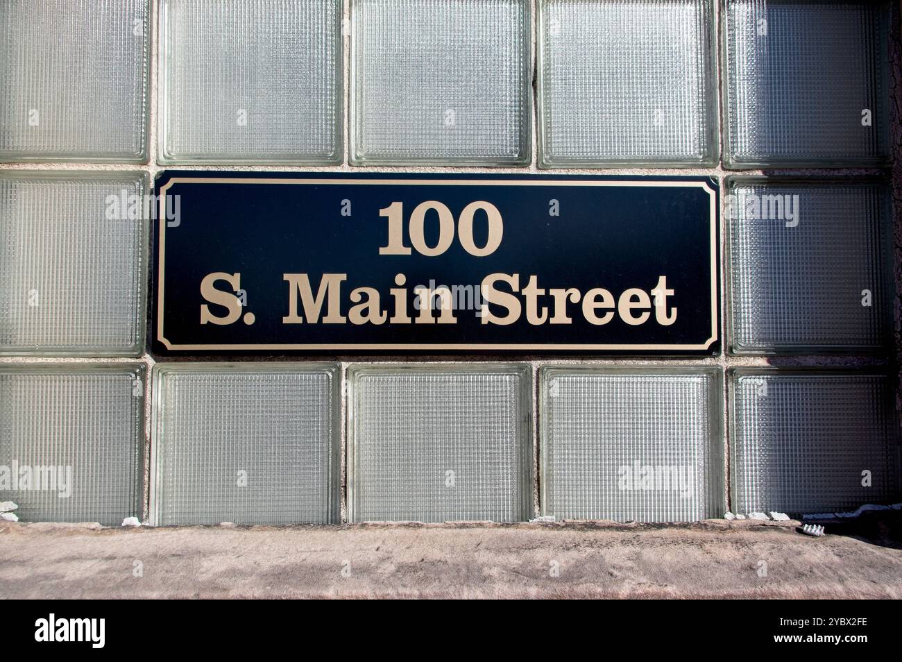 Street address marker embedded in a glass block window Stock Photo - Alamy