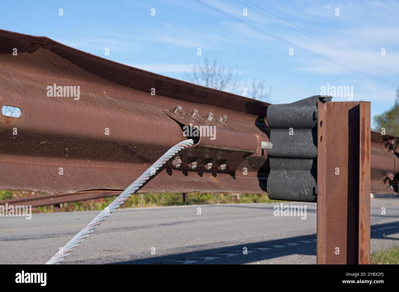 Back side of a highway guardrail with a steel cable Stock Photo - Alamy