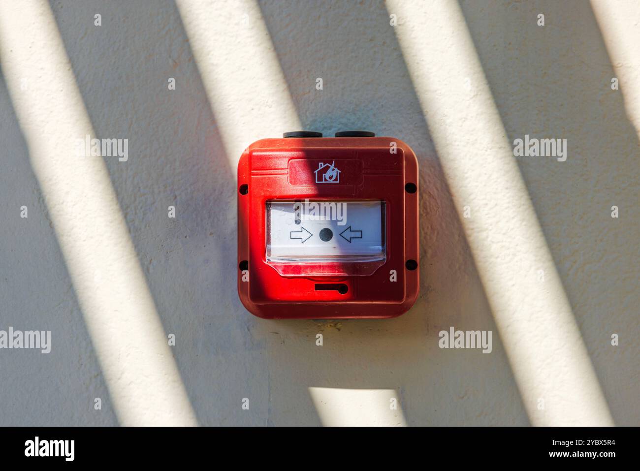 Red fire alarm box with arrows symbolizing emergency activation system ...