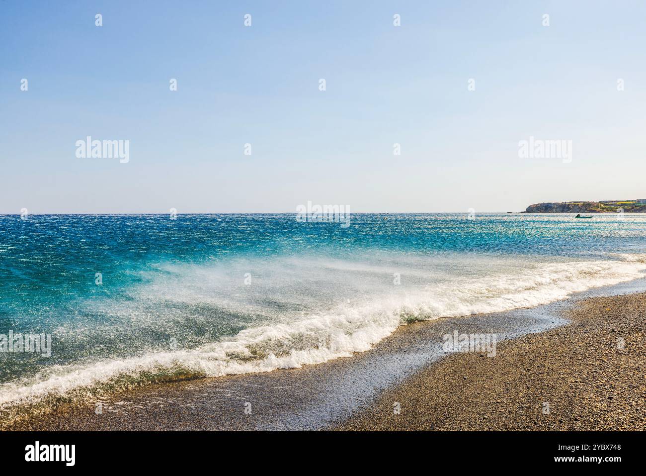 Offshore wind blowing waves away from rocky beach, Mediterranean Sea ...