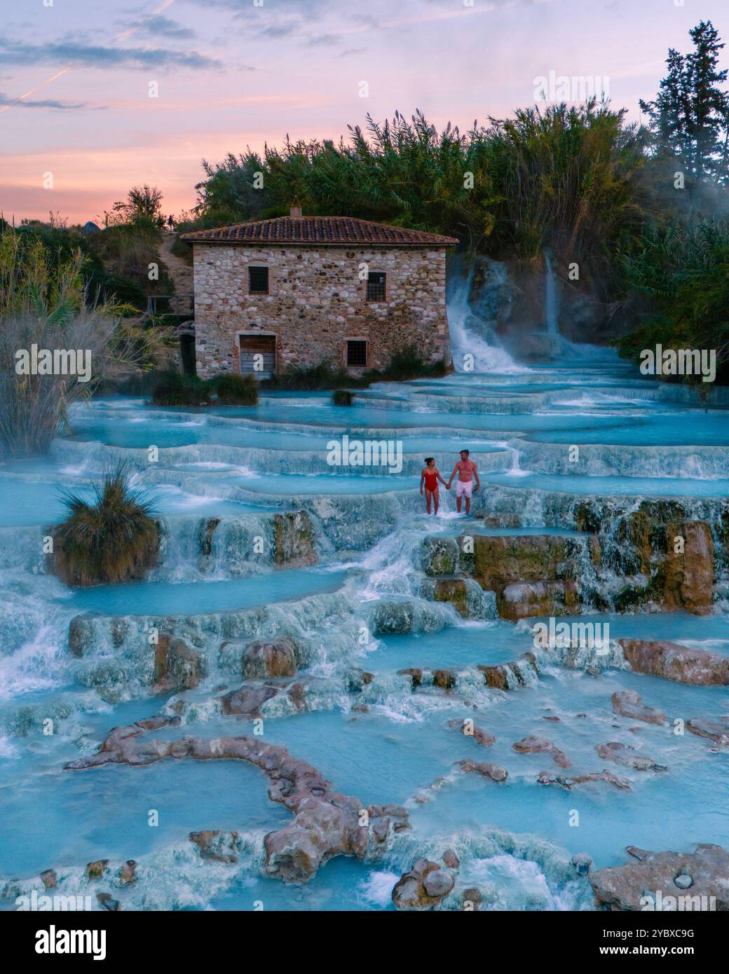Visitors enjoy the warm, mineral-rich waters of Saturnia thermal baths ...