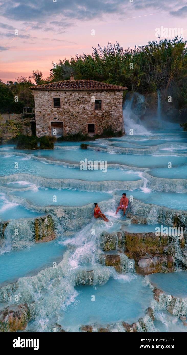 Visitors unwind in the captivating turquoise waters of Saturnia thermal ...