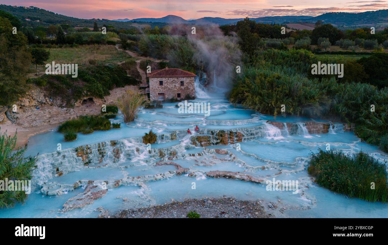 Visitors unwind in the natural thermal baths of Saturnia, surrounded by ...