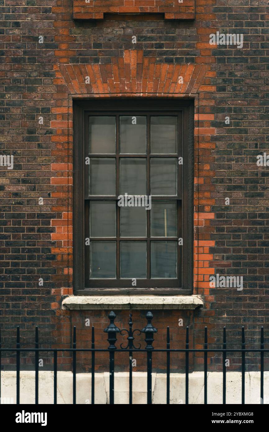 Classic Brick Building with Traditional Window and Iron Fence Stock ...