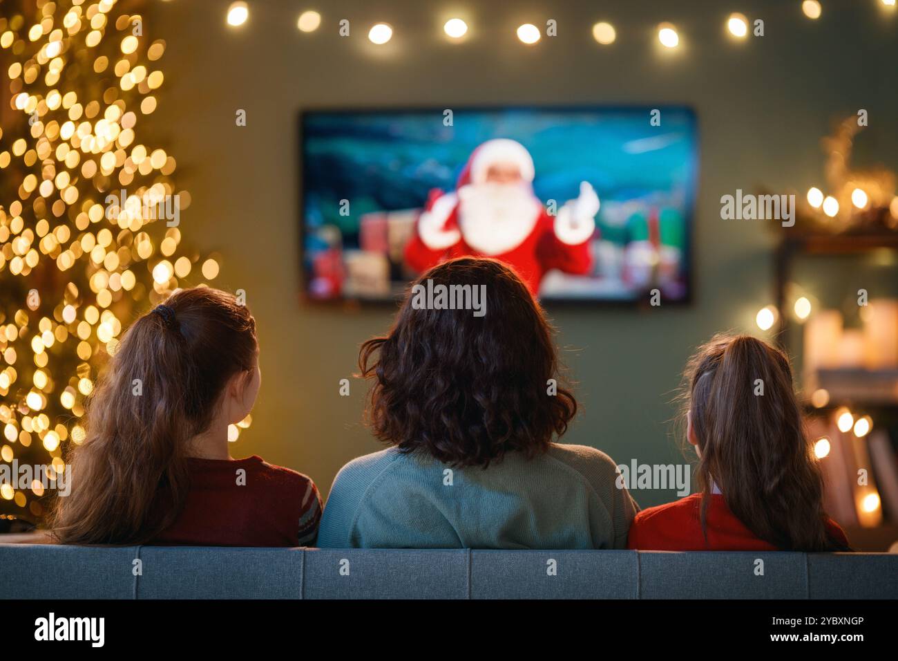 Merry Christmas and Happy New Year. People having fun near tree indoors ...