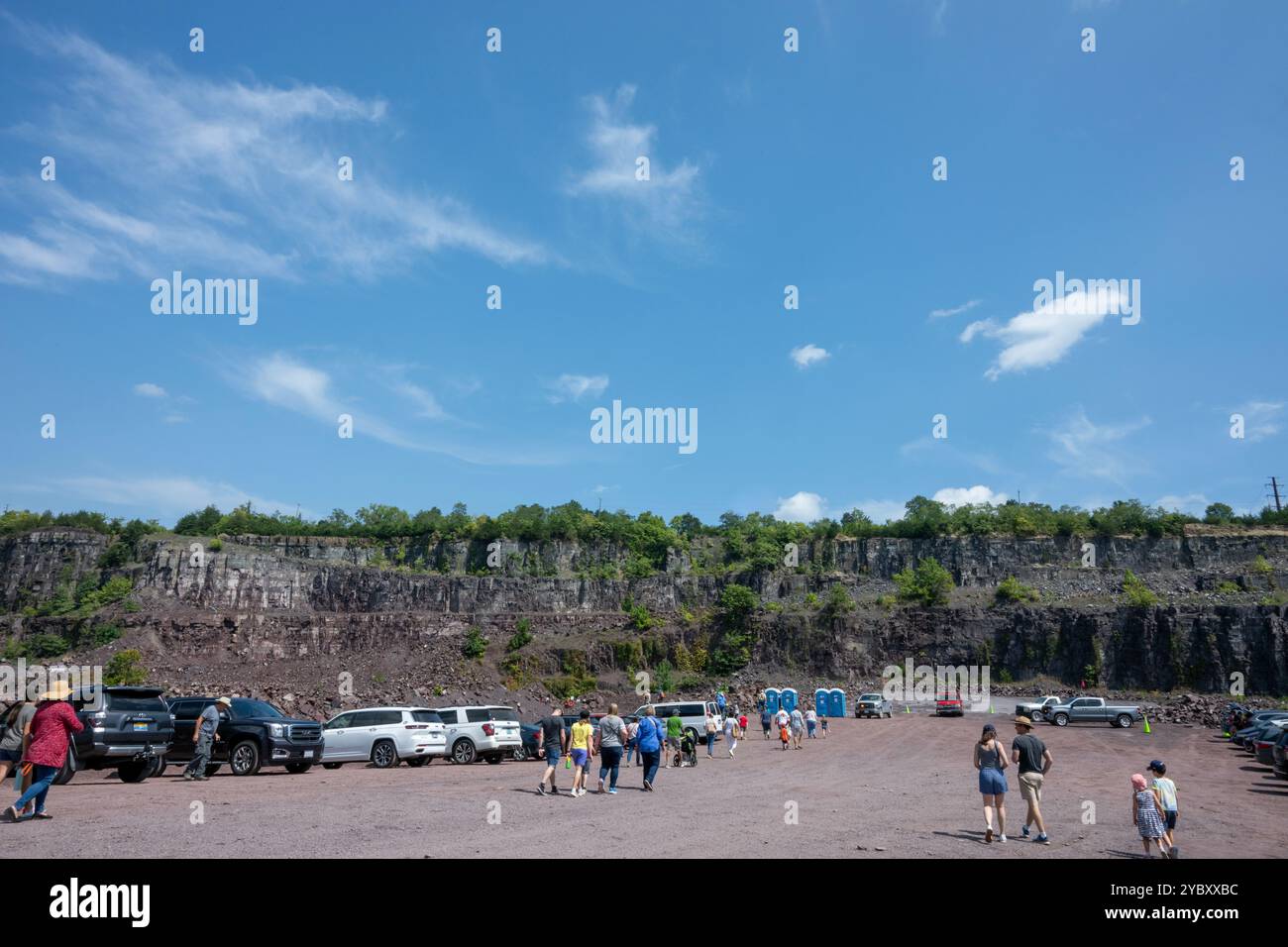 Visitors park their cars at the bottom of a quarry and walk toward the ...