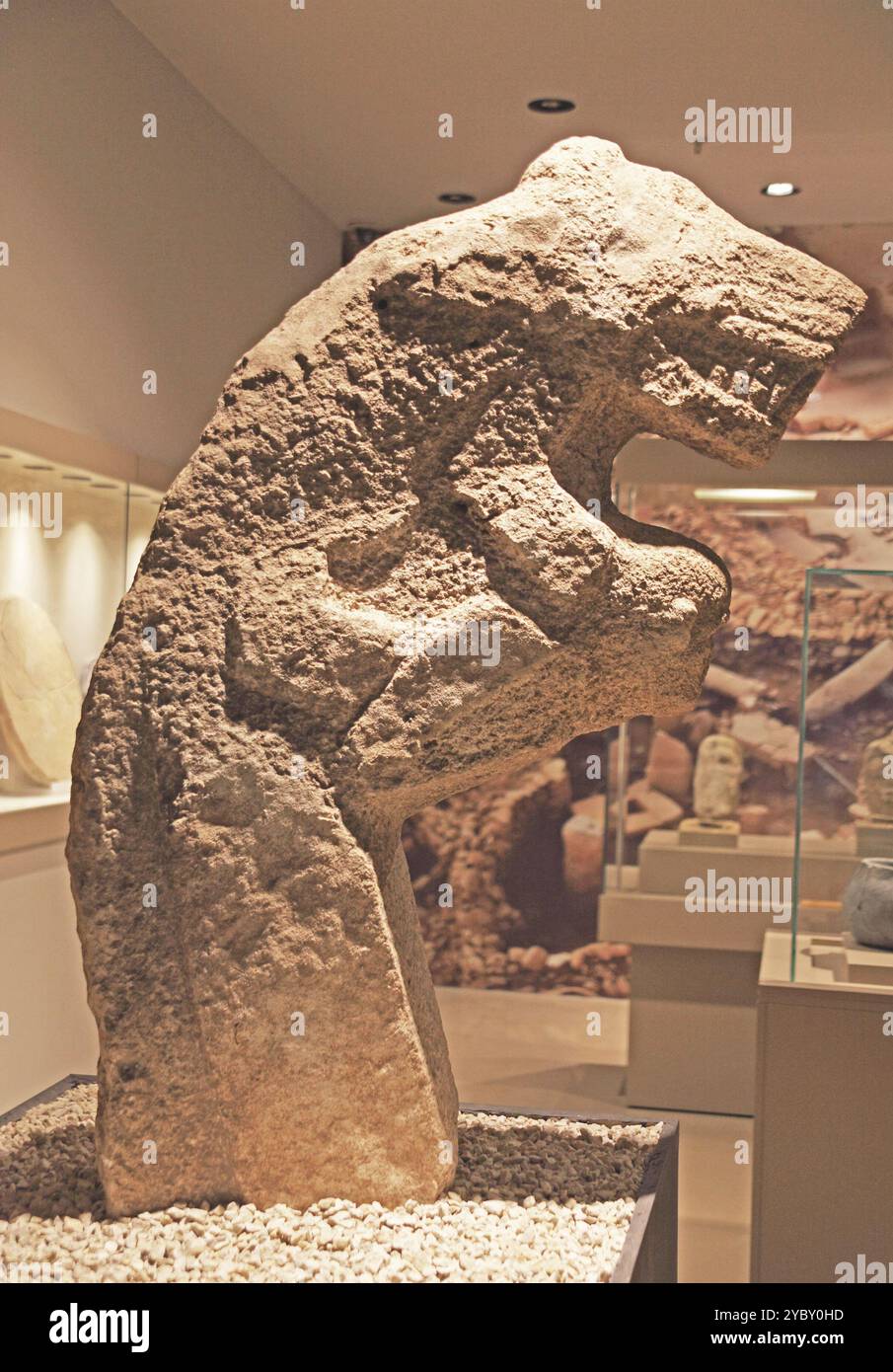 Carving of a leopard or lioness with bared teeth holding a human ...