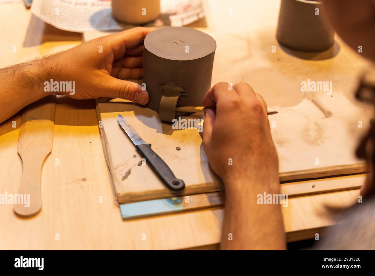 A potter's hands shaping a clay vessel on a pottery wheel, Ceramic ...