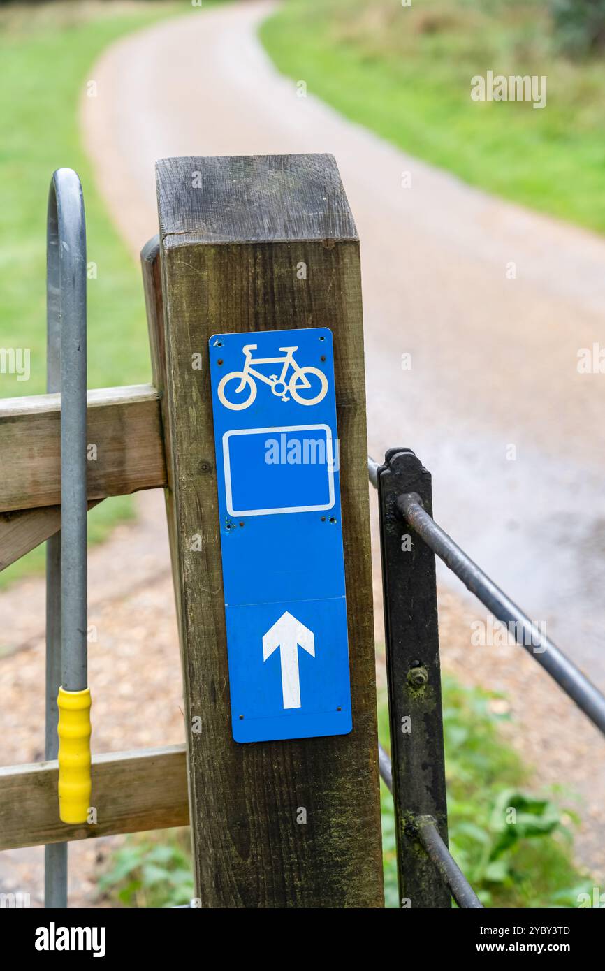 Wooden signpost with National Cycle Route and symbol of a bike in ...