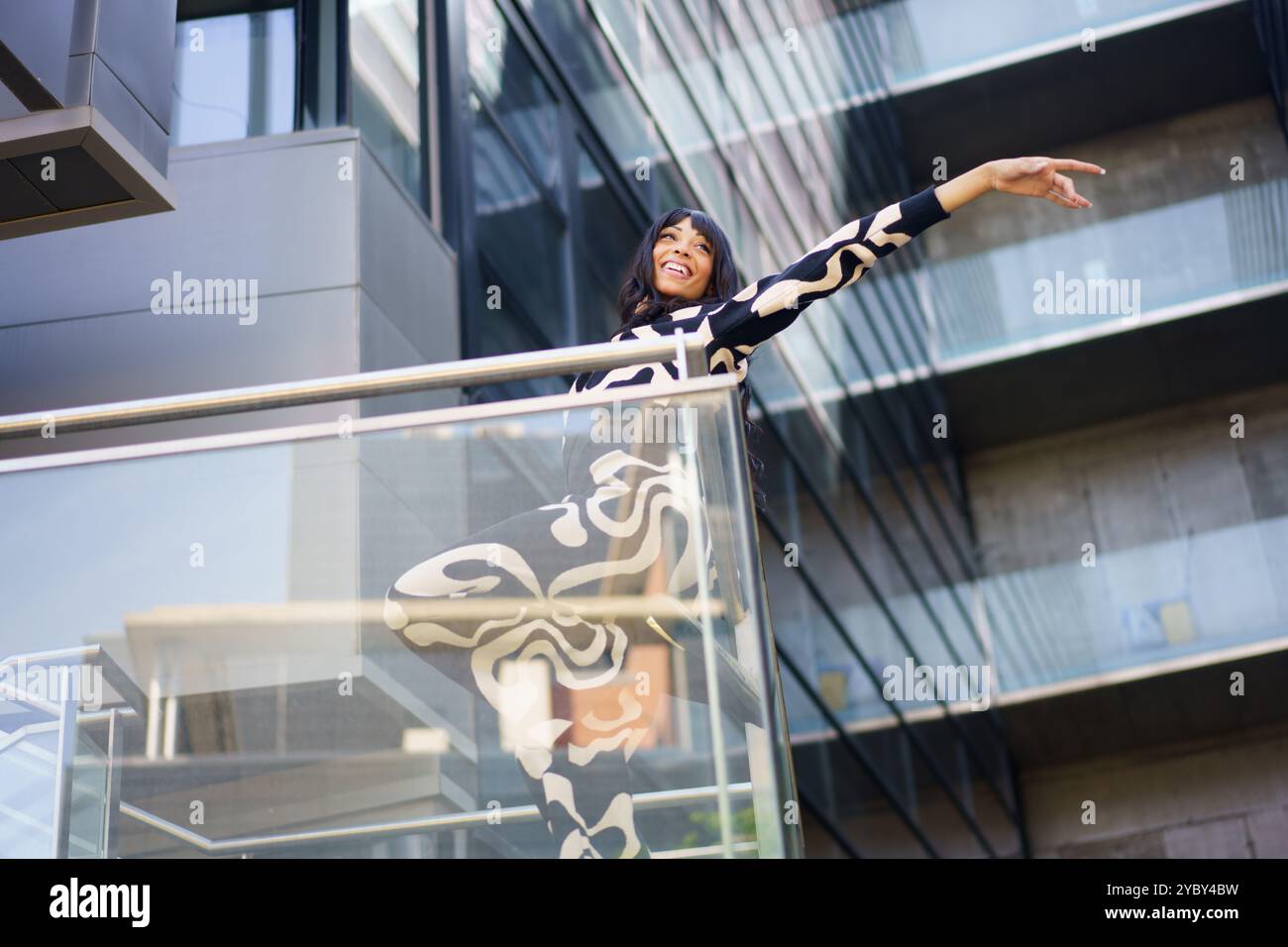 Dancer performing from crystal stairs of a modern building Stock Photo ...