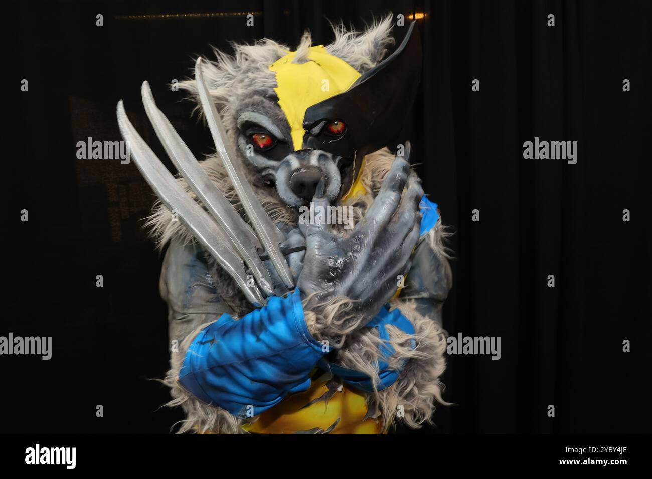 A cosplayer dressed as werewolf and wolverine combo poses for a photo ...