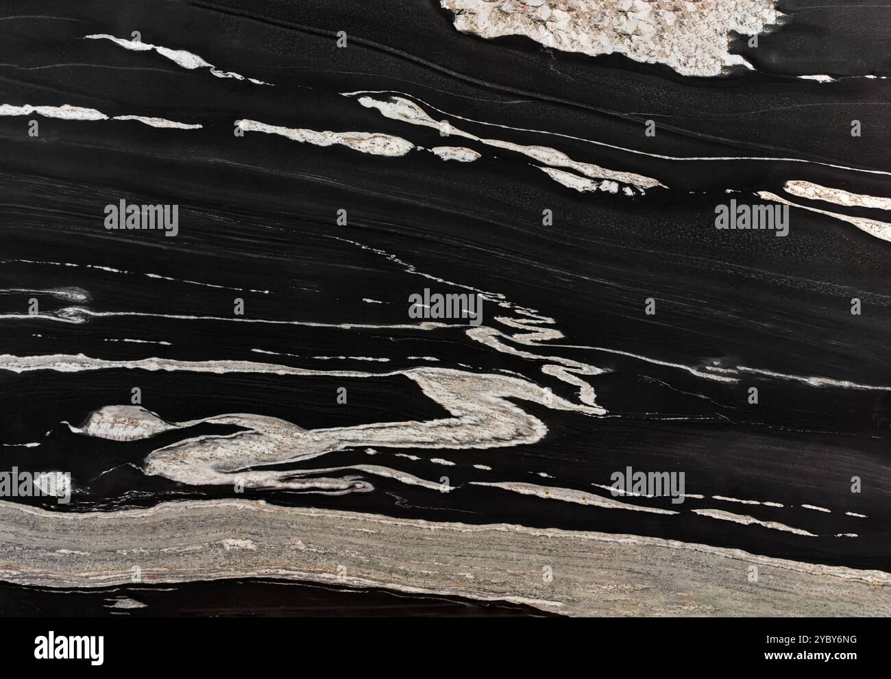 Black granite slab with bold white veining, providing a textured ...
