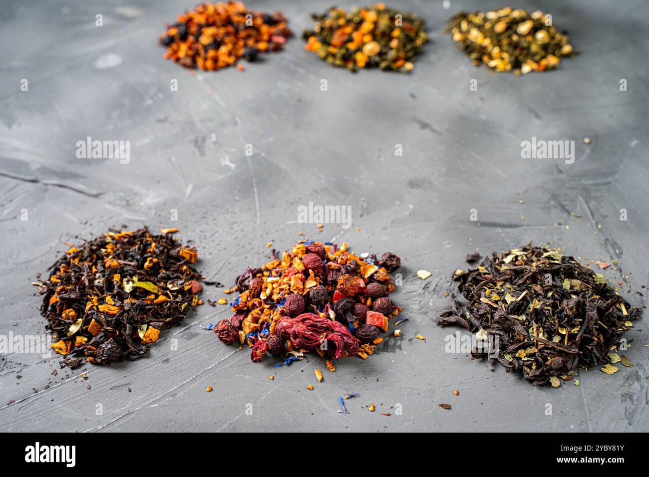 Assorted dry tea of different varieties with additives on a gray ...