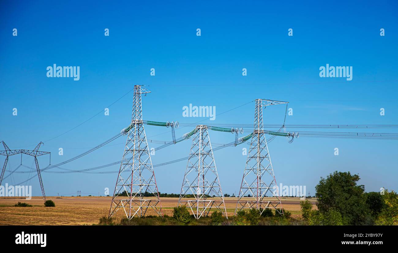 High voltage power line against the blue sky. Metal wires on a high ...