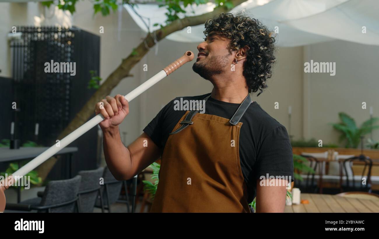 Happy playful Latino American ethnic male man guy in apron waiter ...