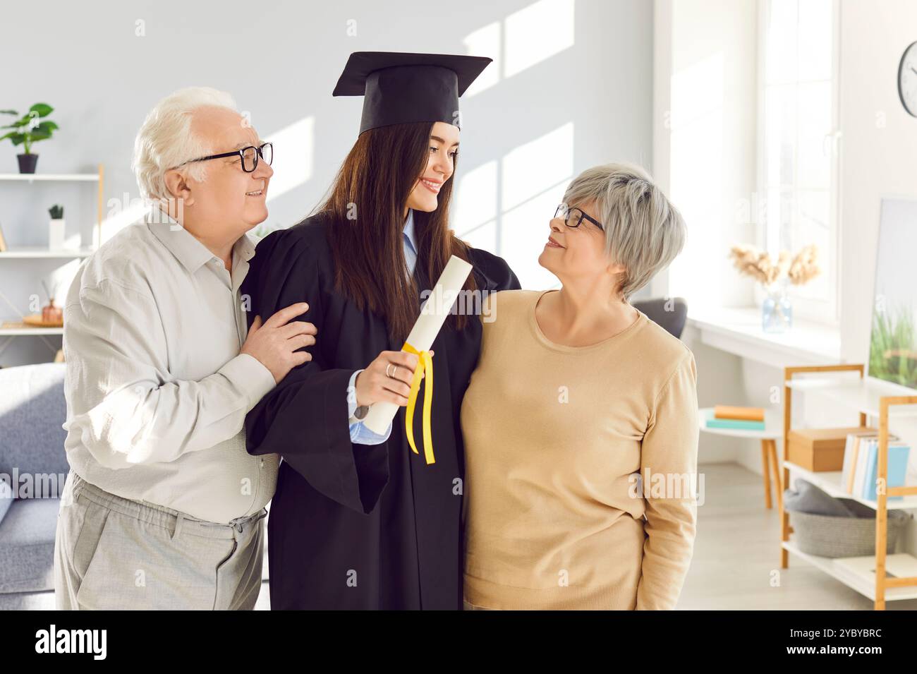 Elderly Parents Congratulate Graduate Student Daughter Stock Photo - Alamy