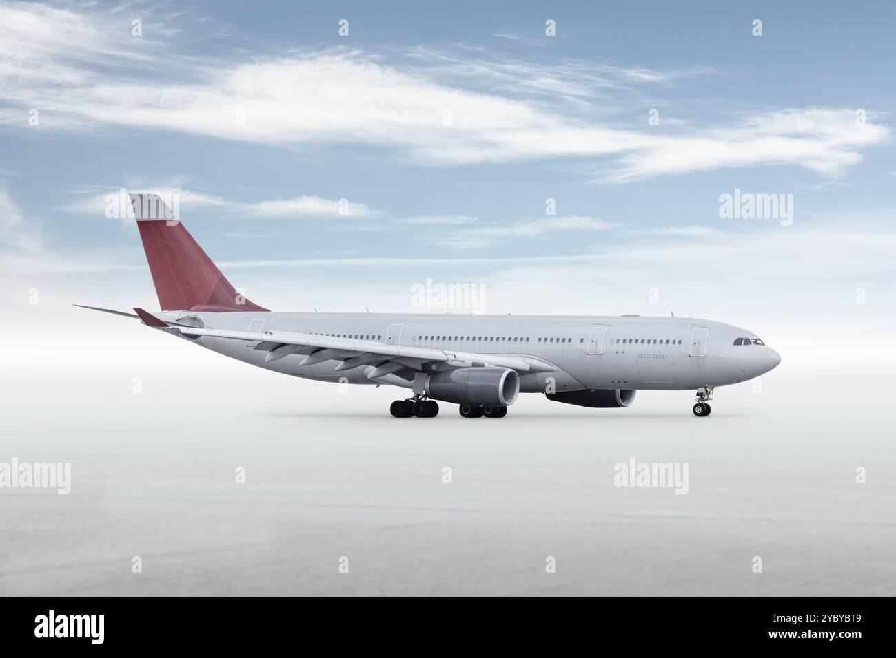 Wide body passenger aircraft isolated on bright background with sky ...