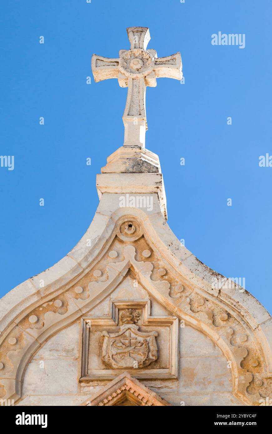 A detailed view of a prominent cross atop a historic structure ...