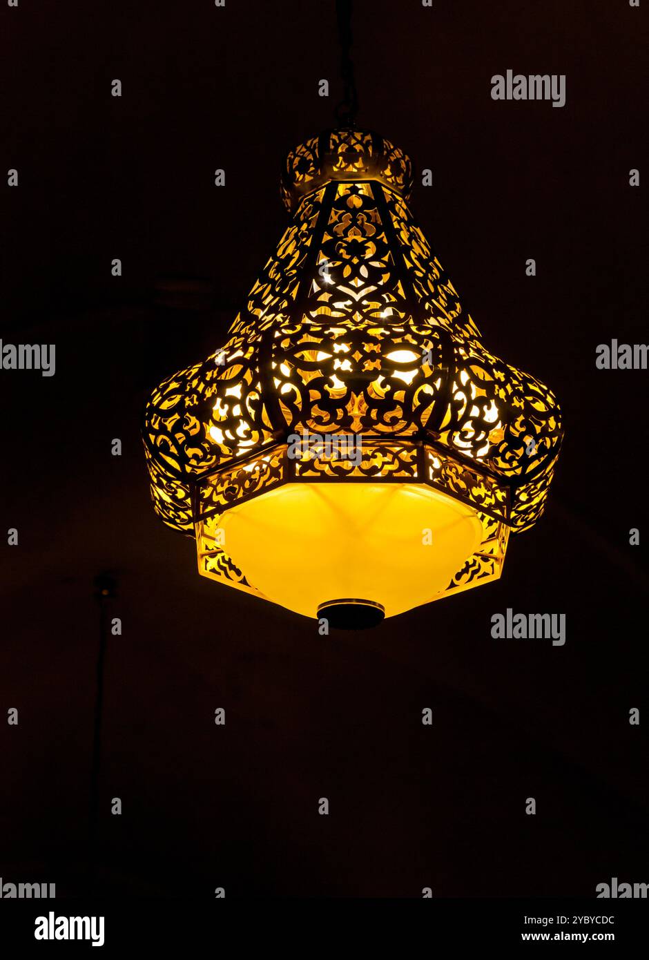 Traditional metal Morocco lantern with intricate pattern over black ...