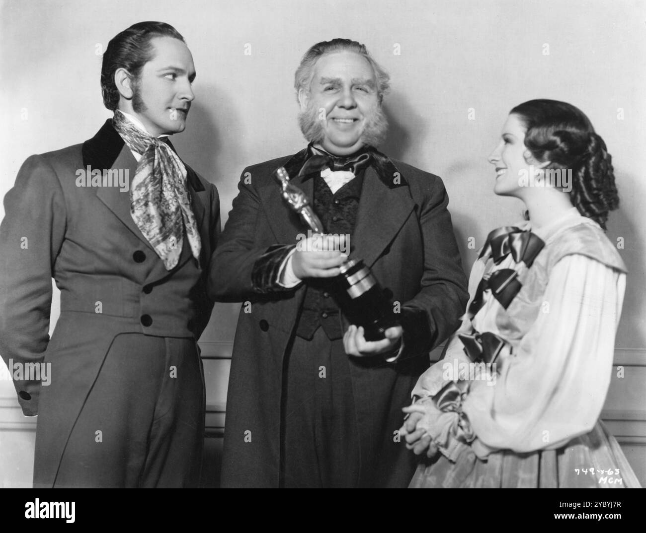 British Actor CHARLES LAUGHTON holds the Best Actor Oscar that he won ...