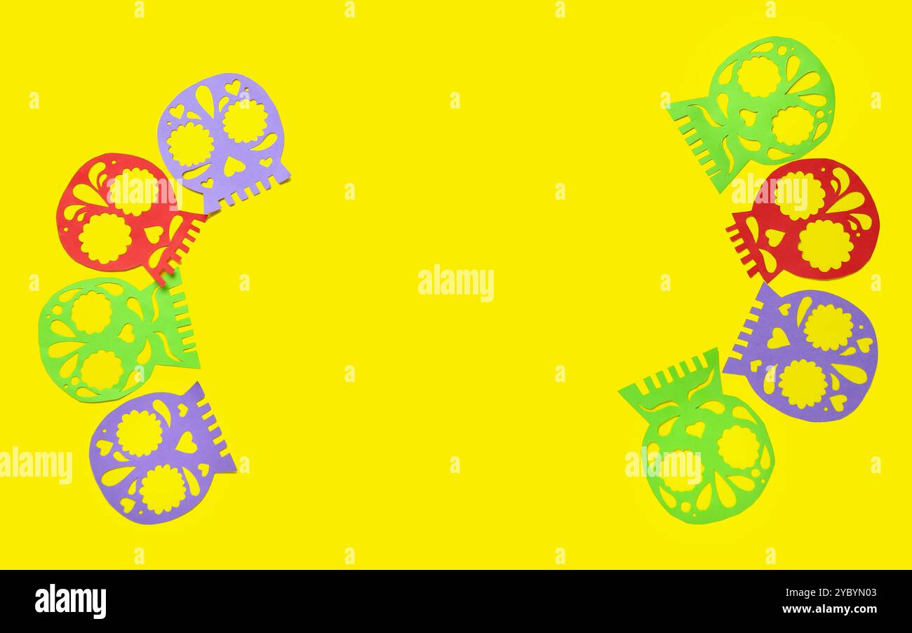 Colorful paper skulls on yellow background. Celebration of Mexico's Day ...