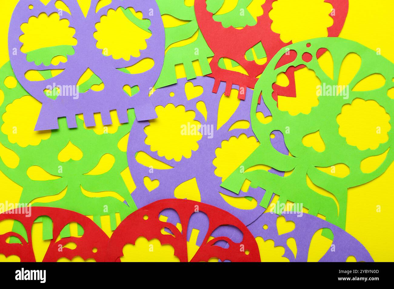 Colorful paper skulls on yellow background. Celebration of Mexico's Day ...