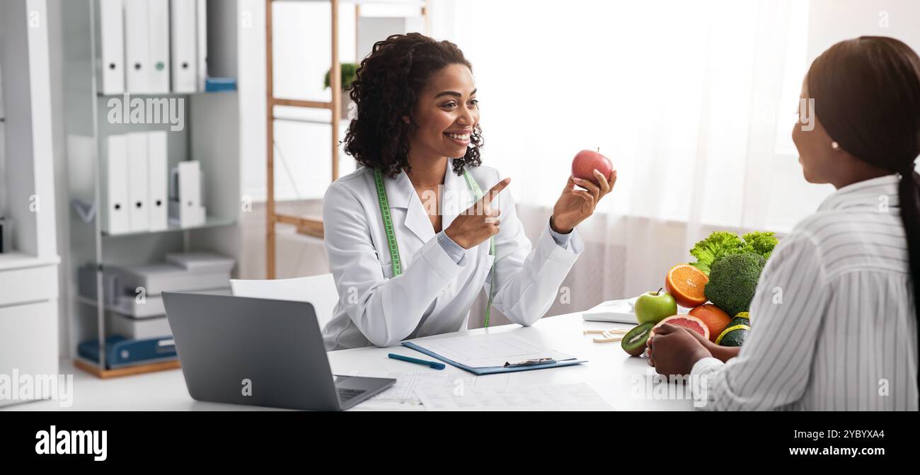 Nutritionist giving consultation to patient with healthy fruit and ...