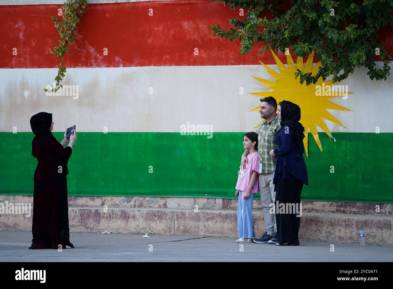 Duhok, Iraq. 20th Oct, 2024. Kurdish voters take a photo in front of ...