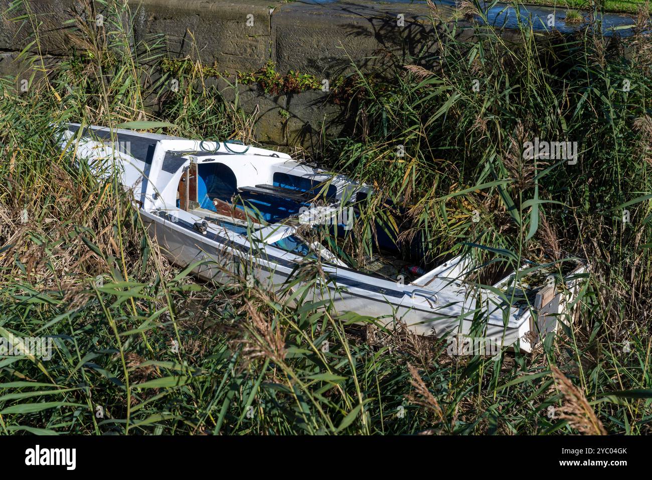 Abandoned and damaged boats on a canal Stock Photo - Alamy