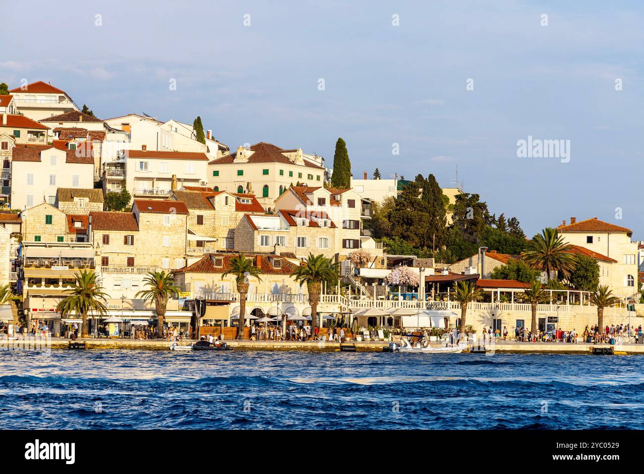 Stone houses on a hillside and waterfront promenade in Hvar Town, Hvar ...