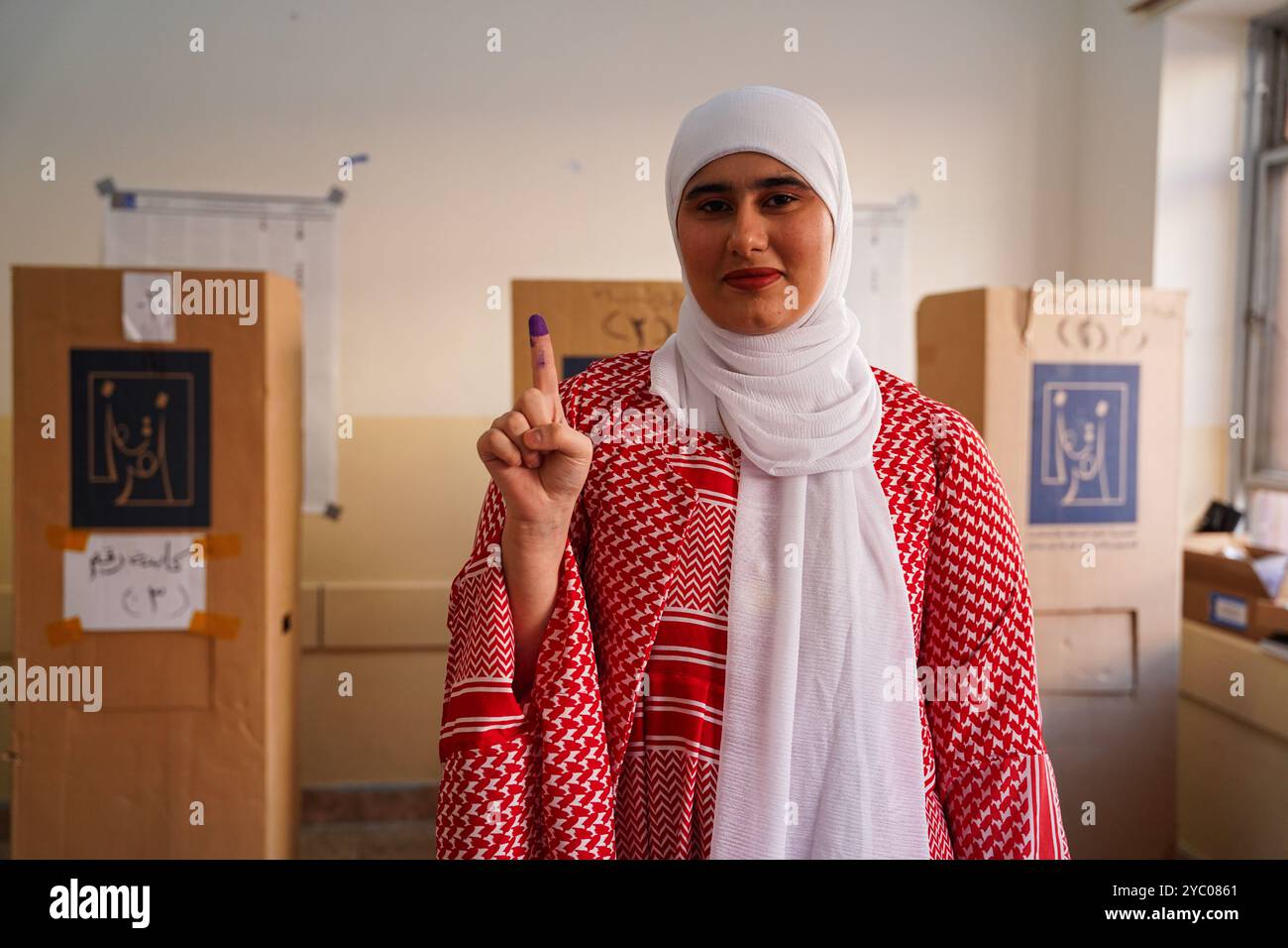 Duhok, Iraq. 20th Oct, 2024. A Kurdish girl voter displays her ink ...