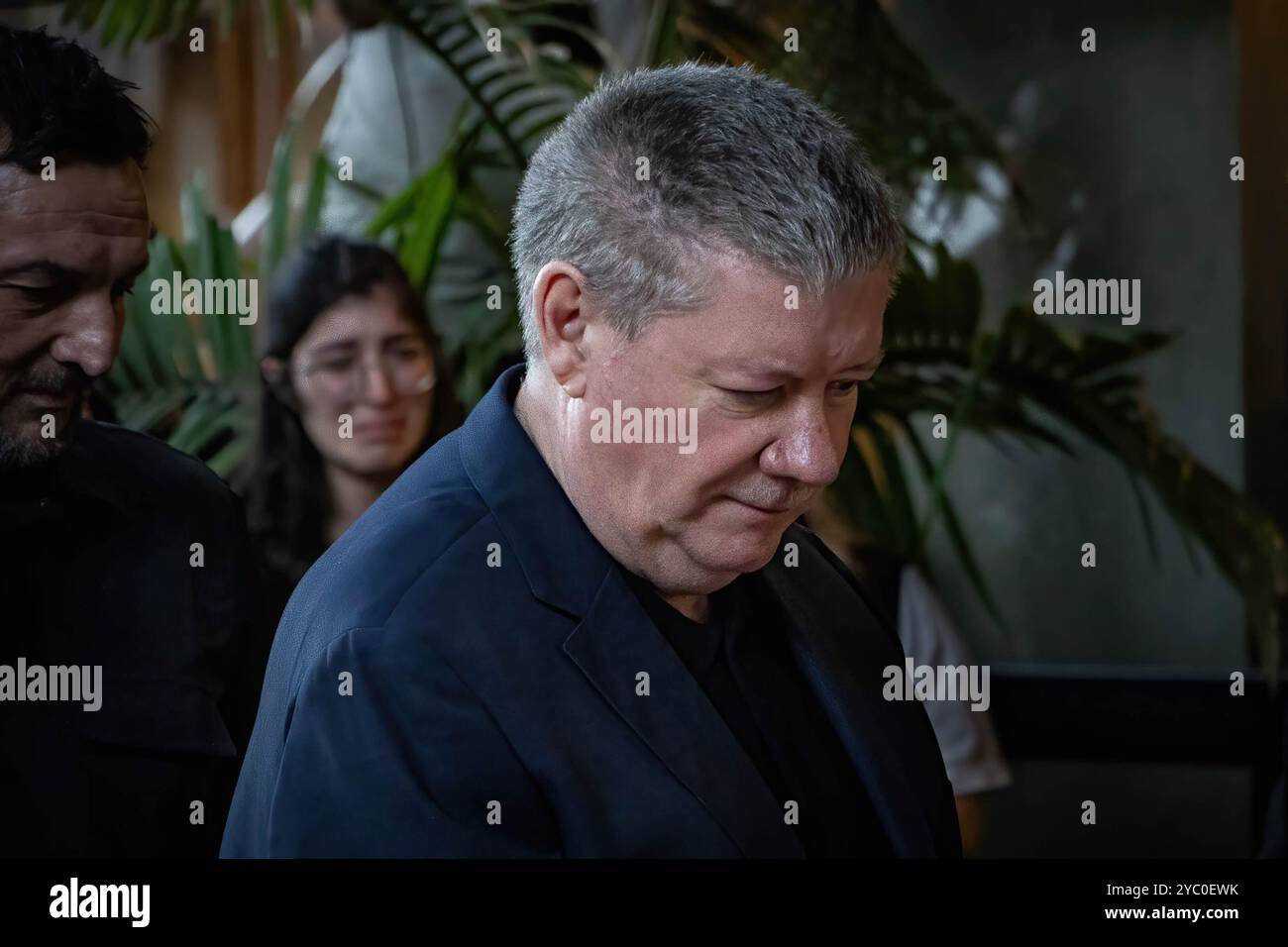 Liam's father, Geoff Payne, reads one of the letters left by the fans ...