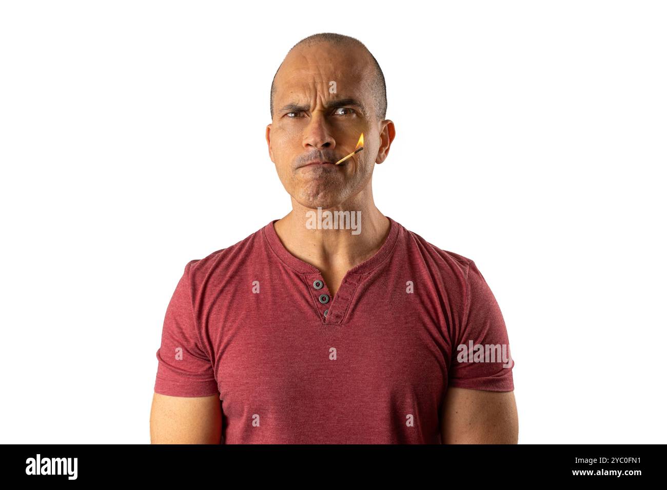 48 year old Brazilian man, facing the camera and with a lit match in ...