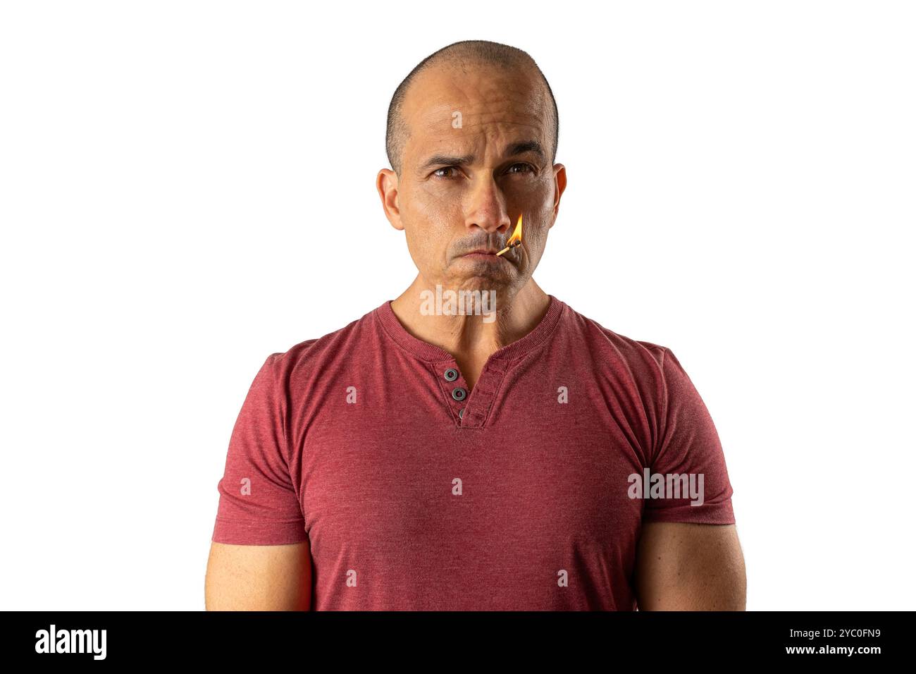 48 year old Brazilian man, facing the camera and with a lit match in ...