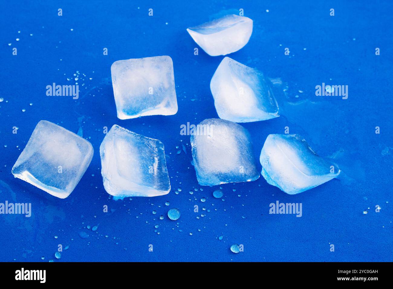 Many ice cubes on blue background Stock Photo - Alamy