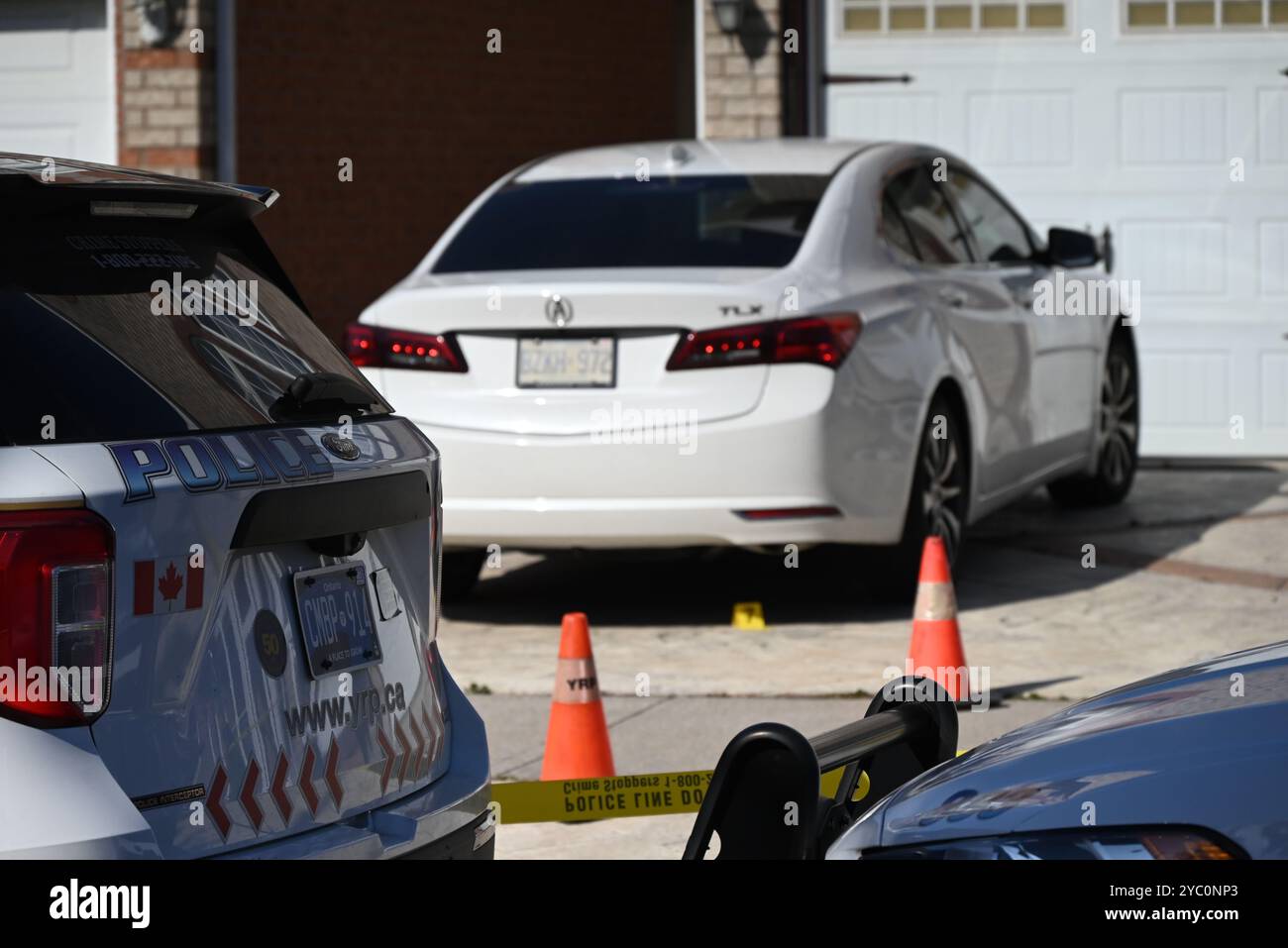 An evidence marker highlighting blood, flip flops and a gold chain that ...