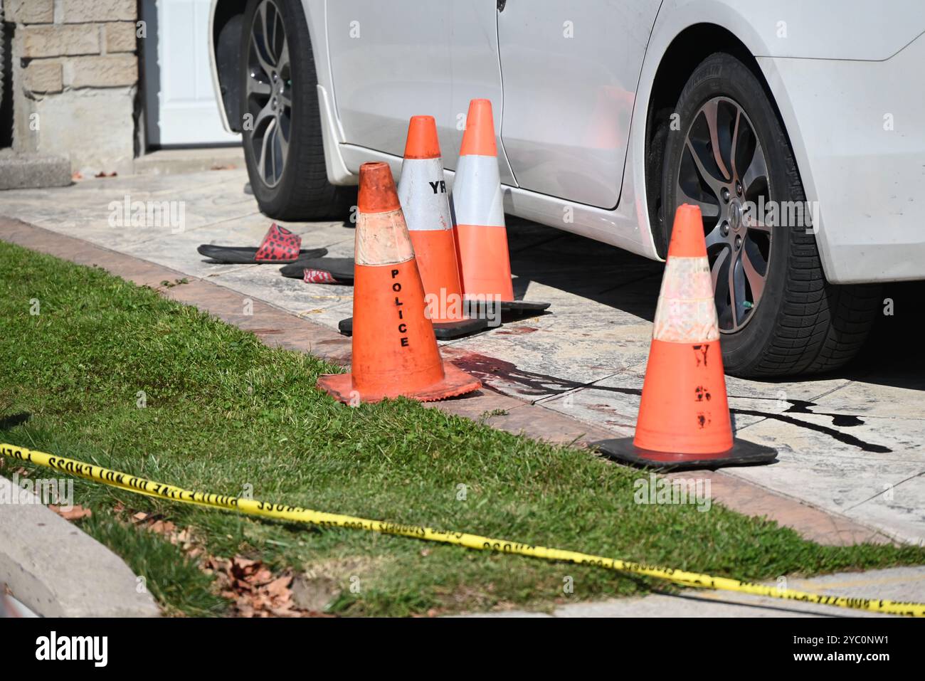 An evidence marker highlighting blood, flip flops and a gold chain that ...
