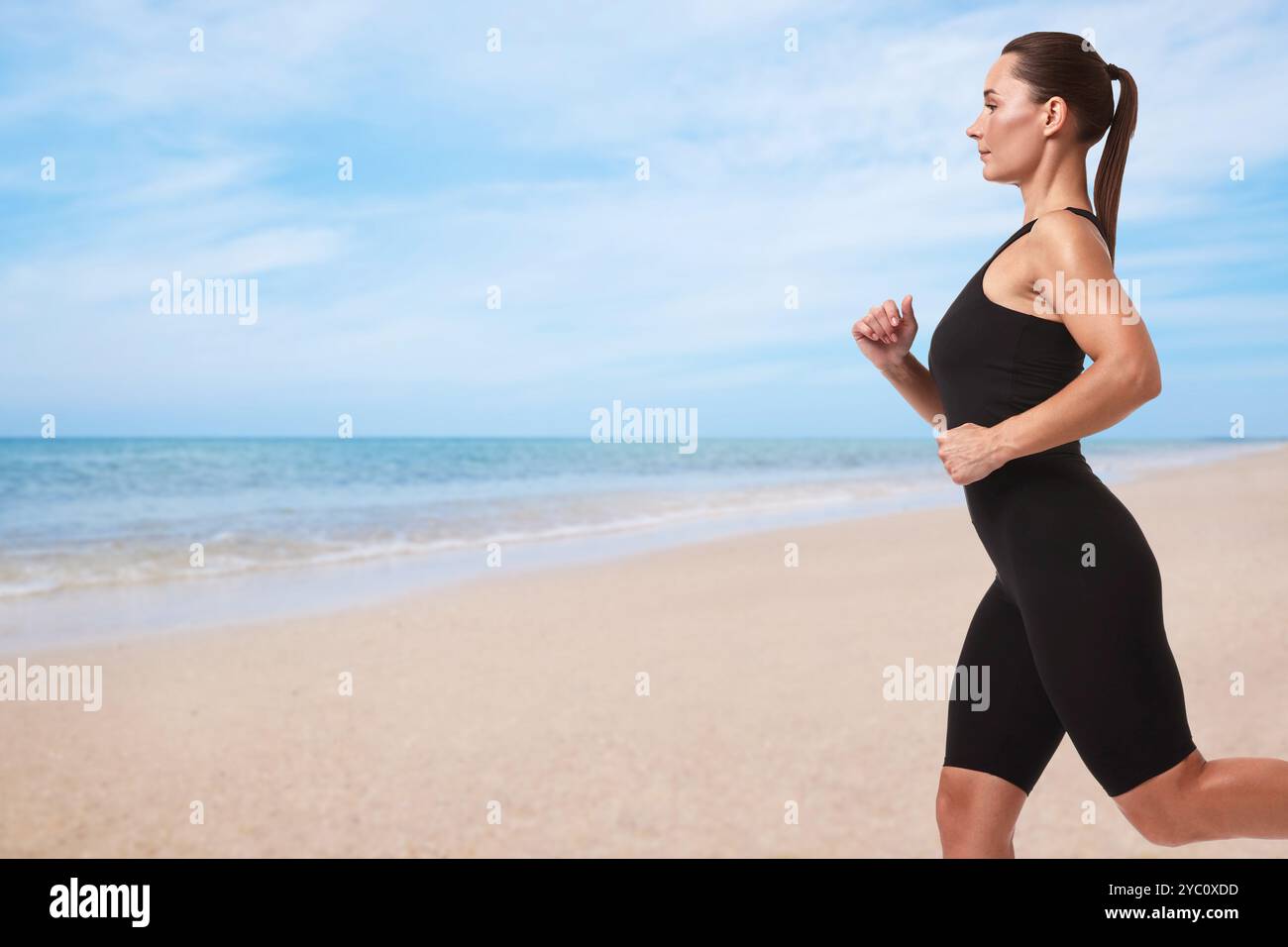 Beautiful woman running on beach. Space for text Stock Photo - Alamy