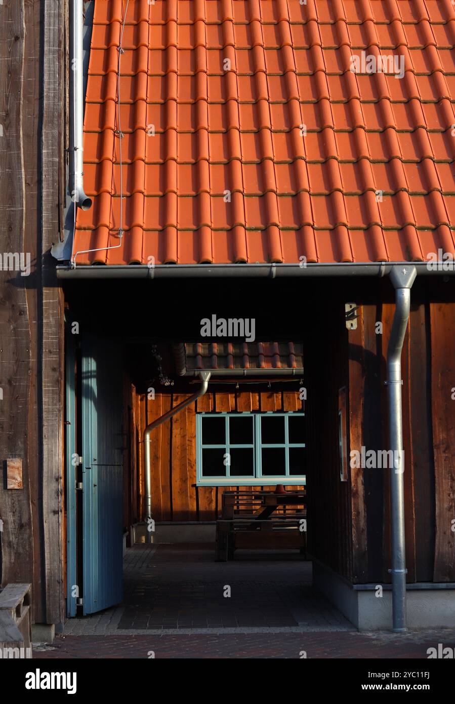 rural building with terracotta tiled roof, weathered wooden walls ...