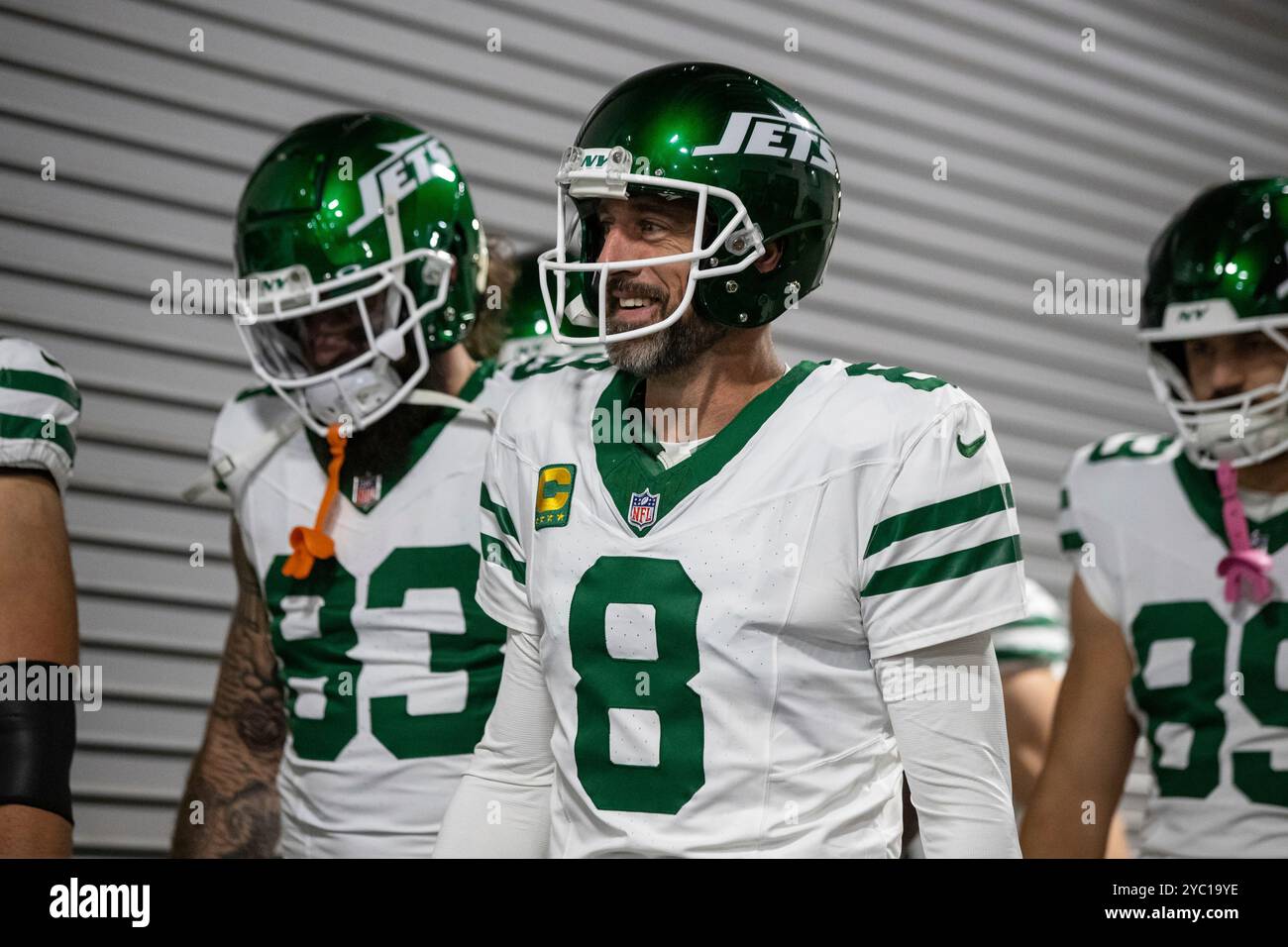 New York Jets quarterback Aaron Rodgers (8) leads the team out of the ...